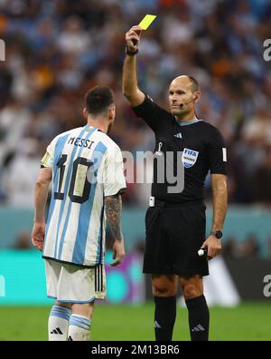 Argentina's Lionel Messi is shown a yellow card by referee Antonio Mateu Lahoz during the FIFA ...