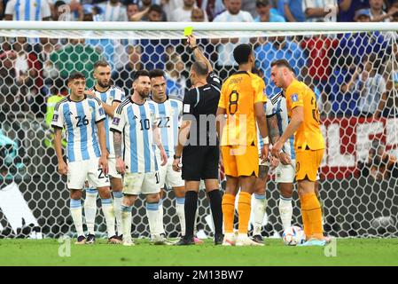Argentina's Lionel Messi is shown a yellow card by referee Antonio Mateu Lahoz during the FIFA ...