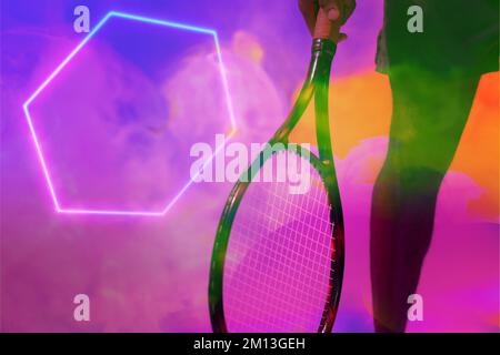 Midsection of african american male tennis player holding racket by red ...