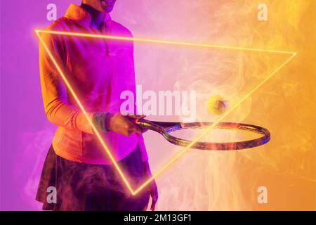 Midsection of american football player with ball standing by ...