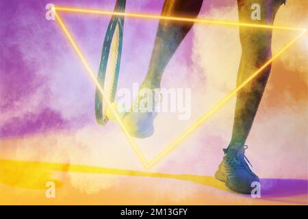 Low section of african american female player with racket and ball by ...