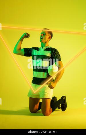 Illuminated triangle over caucasian male player with rugby ball ...