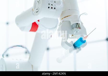 Robotic arm holding syringe Stock Photo - Alamy