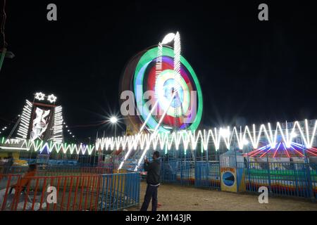 Giant ferris wheel with green lighting in An Exhibition indian Fair at ...