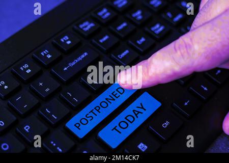 Text sign showing Postponed. Concept meaning to place later in order of ...