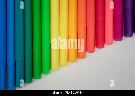 Colorful pens stacked sequentially on a white surface. Great for ...