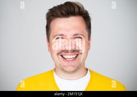 Caucasian crazy man with fake smile on face Stock Photo - Alamy