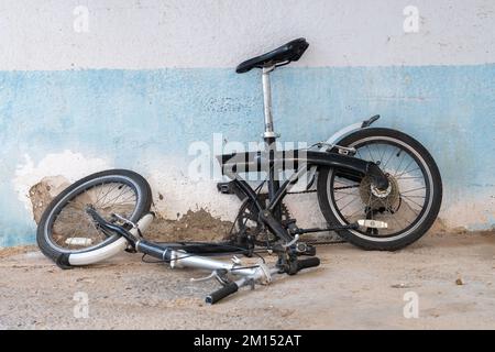 Bicycle with a frame broken in half stands on the street Stock Photo ...
