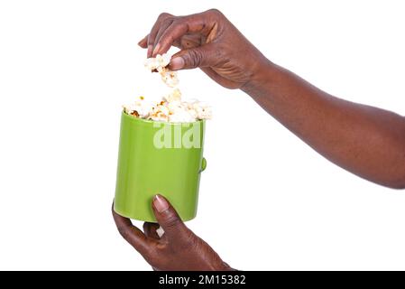 portrait of a female hand taking popcorn from a cup. isolated on white ...