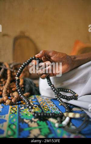 Muslim man with misbaha praying indoors, closeup. Space for text Stock ...