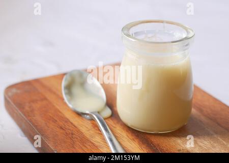 condensed milk in a bowl close up Stock Photo - Alamy