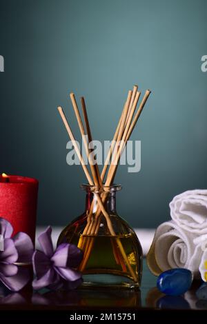aromatic reed diffuser with candles and flowers Stock Photo - Alamy