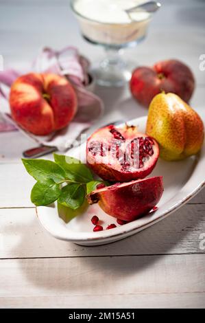 Table still life with pomegranates peaches pears and curd dessert Stock ...