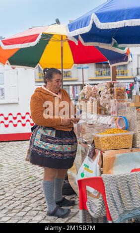 Nazare, Portugal - 09.12.2022: woman in traditional clothing selling ...