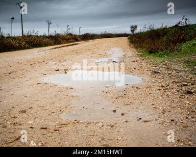 muddy road on a rural highway flooded by winter rains hd image Stock ...
