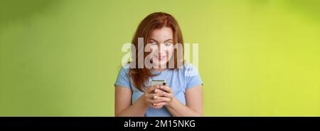 Intrigued excited tempting redhead middle-aged woman shopping online ...