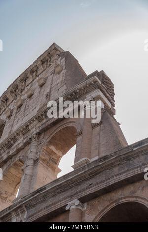 Low angle of famous Colosseum buildings with arches located against ...