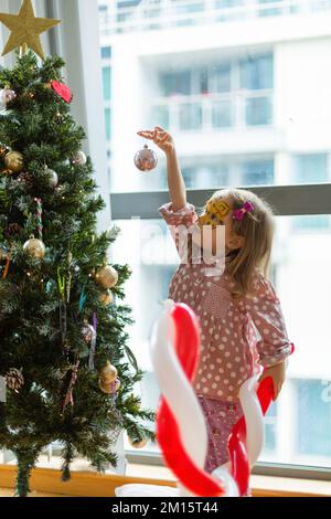 Little girl reaching for balloon Stock Photo - Alamy