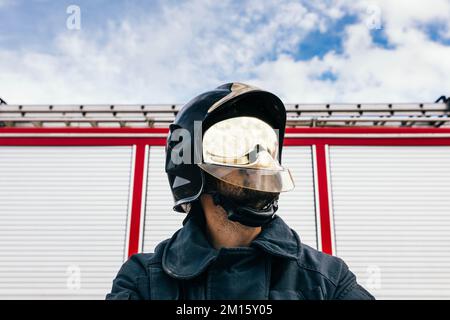 Unrecognizable self assured anonymous male firefighter in protective ...