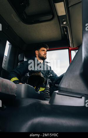 A fire engine sitting ready in a station Stock Photo - Alamy