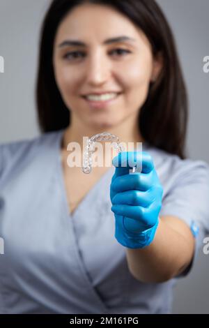 Close-up of orthodontic silicone transparent teeth aligner in female ...