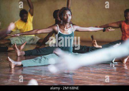Female contemporary dancer and dancers doing workout at dance school in ...