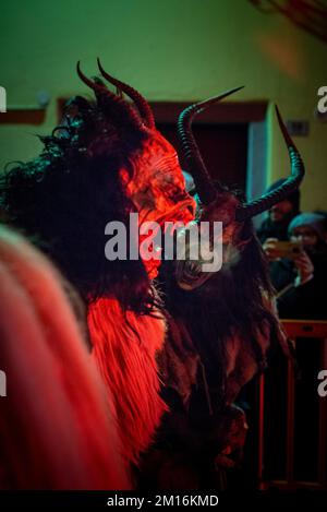 Masked devil beasts parade through the village scaring the crowd while ...