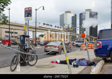 A man with beers and a ghetto-blaster sleeping on the sidewalk Beaubien ...