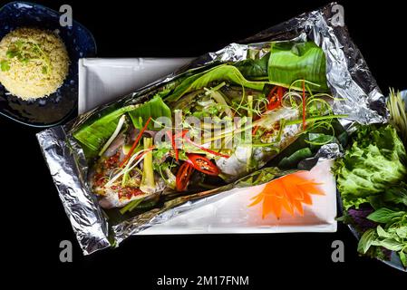 Parrot fish grilled in Vietnamese style with vegetables and white rice ...