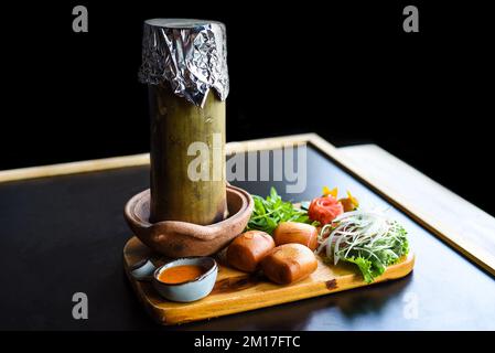 Beef stew with vegetables and banh mi bread on wooden chop board ...