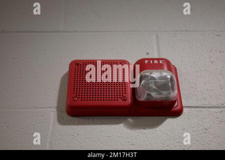 wall mounted Red fire alarm button used to activate warning systems in ...