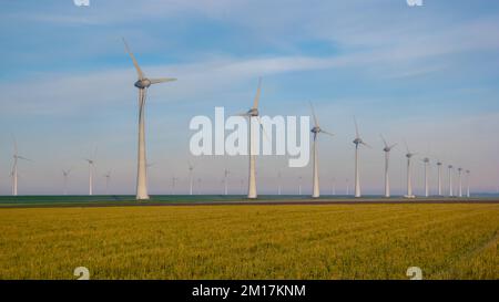 windmill turbines during winter generating electricity with a blue sky ...