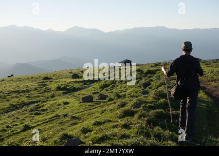 Young man taking an excursion on a mountain Stock Photo - Alamy