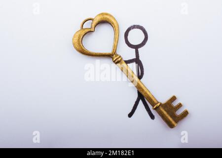 Man carrying a heart shaped key on white background Stock Photo - Alamy