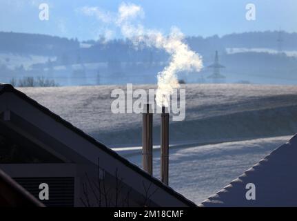 Ruderatshofen, Germany. 11th Dec, 2022. A smoking chimney stands on a ...