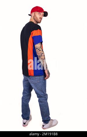 tattooed rap singer posing in studio wearing black clothes on a white ...