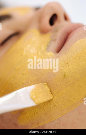 Handsome man having golden mask in beauty studio. Top view of male in ...