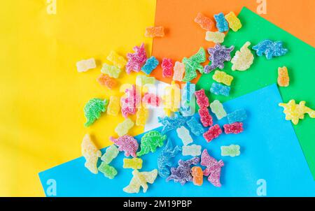 Dinosaurs and bear colorful jelly bonn, candies on the color background ...
