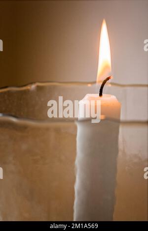 Burning Candle flame inside a glass surrounded by dark background Stock ...