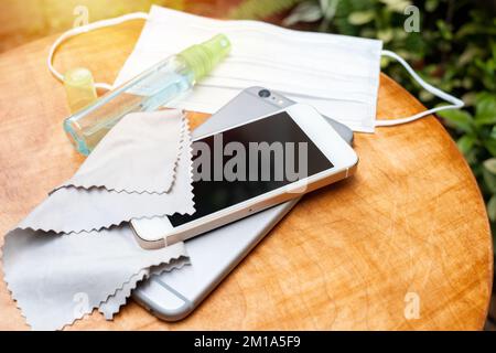 Cleaning the smartphone with soft cloth and alcohol. COVID-19 ...