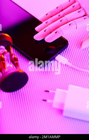 Smartphone charging artificial hand. Mobile phone with connected plug ...