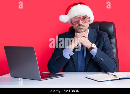mature boss wear red santa claus hat and party glasses hold gift box ...