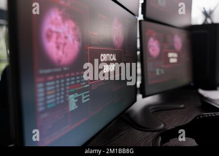 Hacked system alert message showing on multiple monitors flashing security breach error and ...