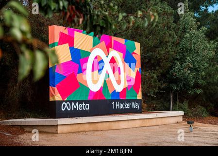 Colorful billboard with logo of meta and 1 hacker way text in front of ...
