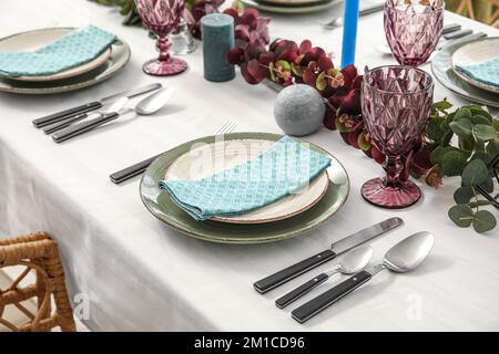 Beautiful setting with eucalyptus branches on served table in light ...