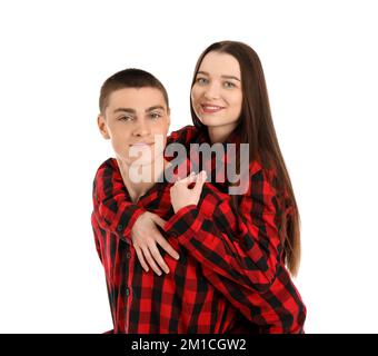 Young couple in checkered pajamas hugging on white background Stock ...