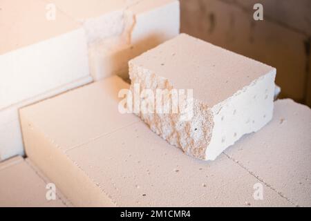 Poor-quality brittle aerated concrete close-up at the place of spalling ...