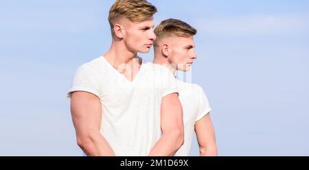 Men twins muscular brothers sky background. Handsome strong twins. Men ...