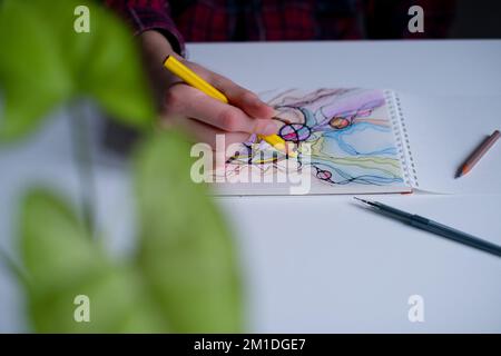Abstract neurographic drawing with pen and colored pencils. Close-up of ...