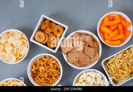 Party snacks, an assortment on gray with copy space Stock Photo - Alamy